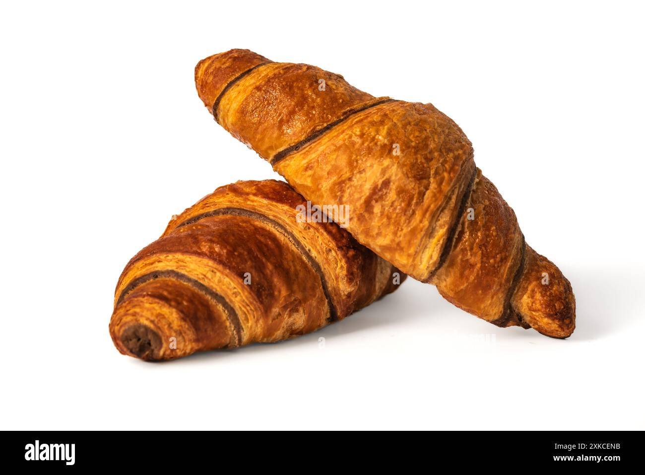 A two perfectly baked croissants, golden brown and flaky, are stacked ...
