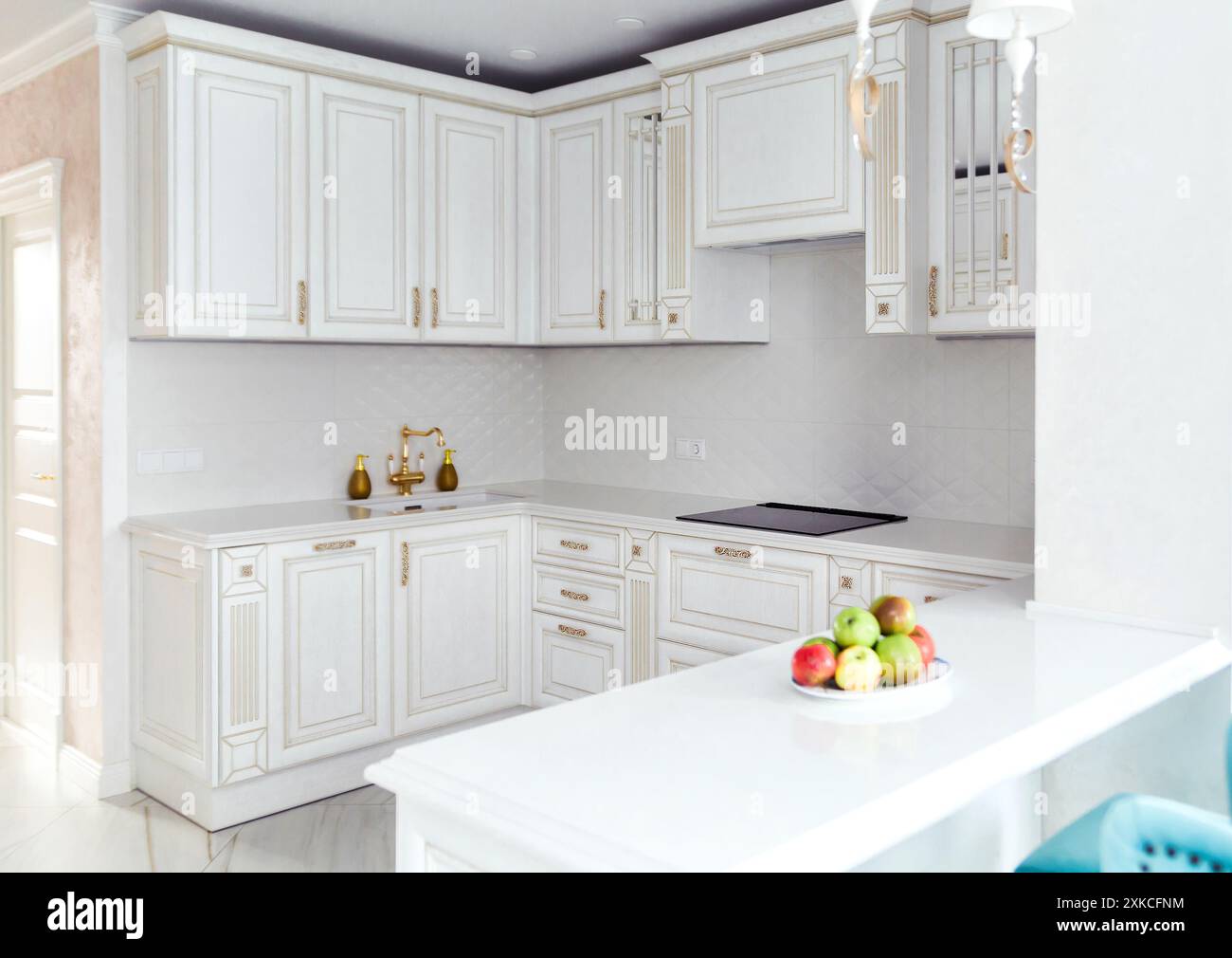 Bright and elegant white kitchen with gold accents, featuring modern ...