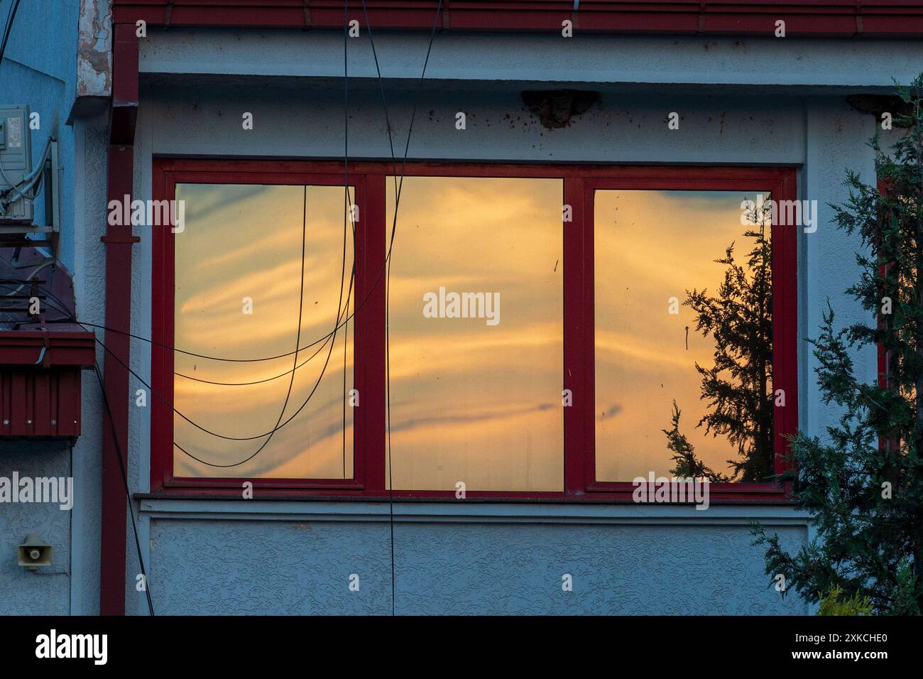 Sunset Glow: Orange Reflection in the Window Frames. White wall ...