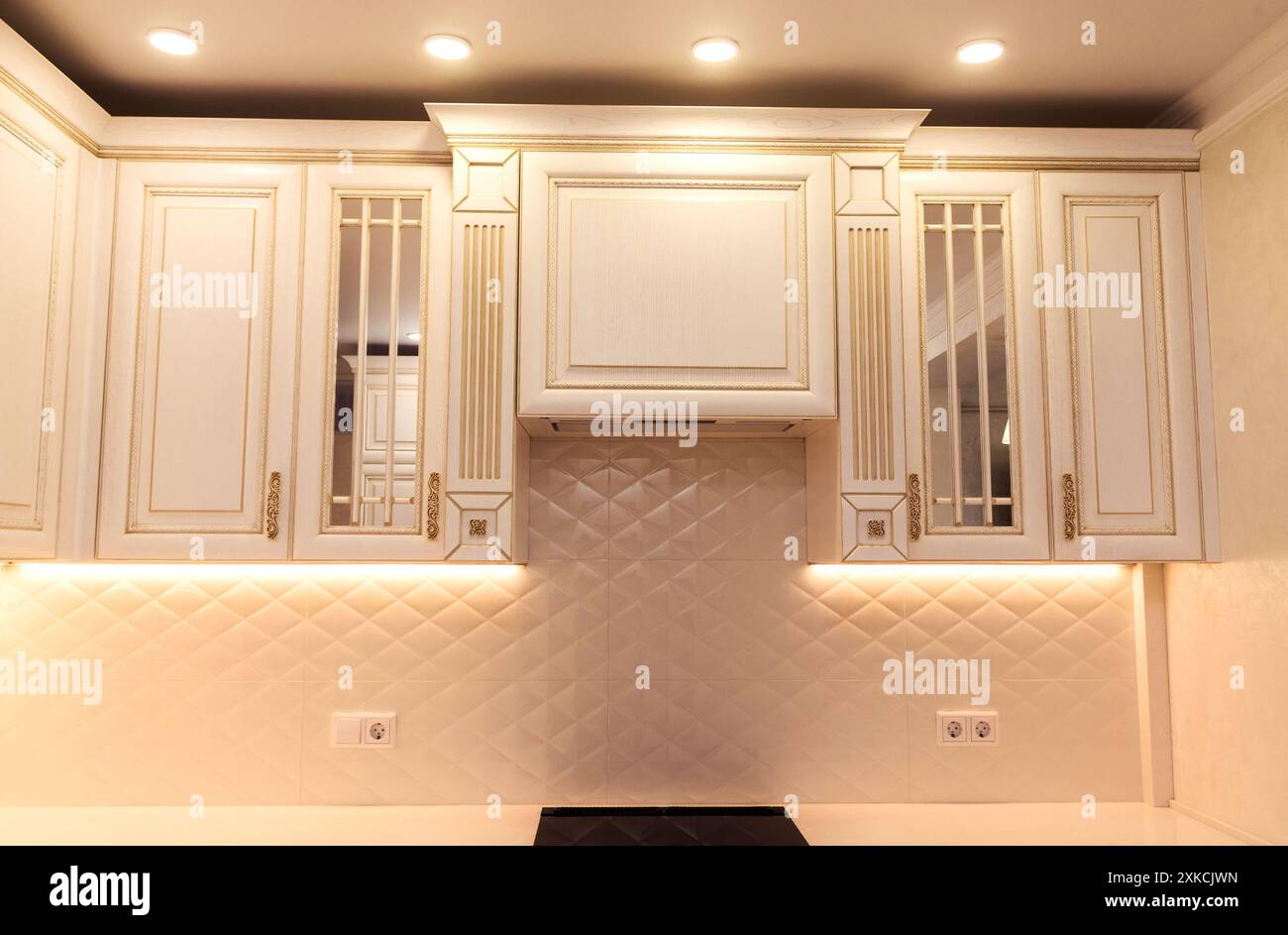 A classic kitchen featuring elegant cabinets and built-in lighting. LED ...