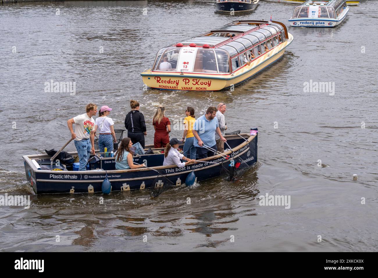 Plastic Whale boat in a canal in Amsterdam, passengers fishing plastic ...