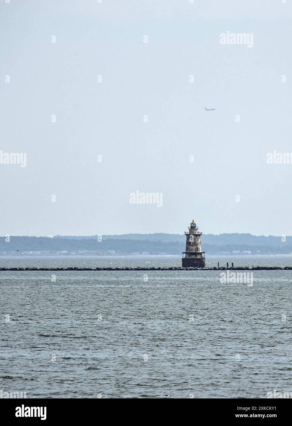 Stamford Harbor Ledge Lighthouse with airplane flying overhead on a ...