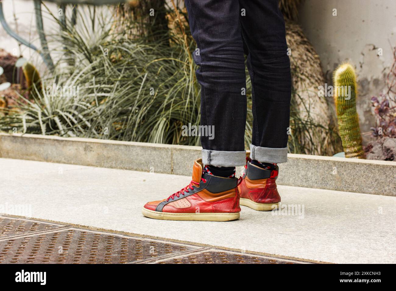 Man, guy in dark blue jeans and leather brown boots standing on path in ...