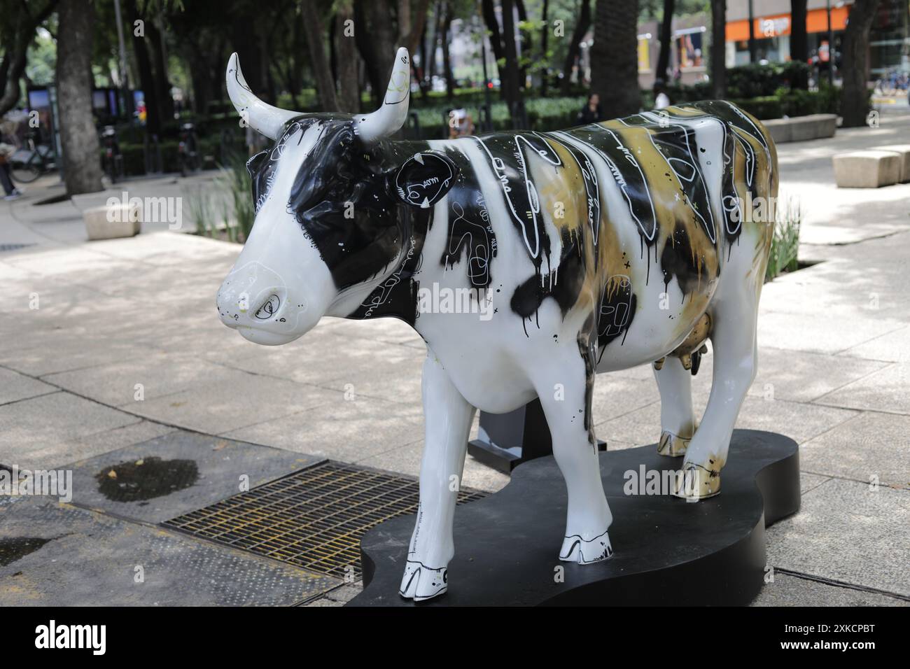 A fiberglass cow painting by an artist is seen during the inauguration ...