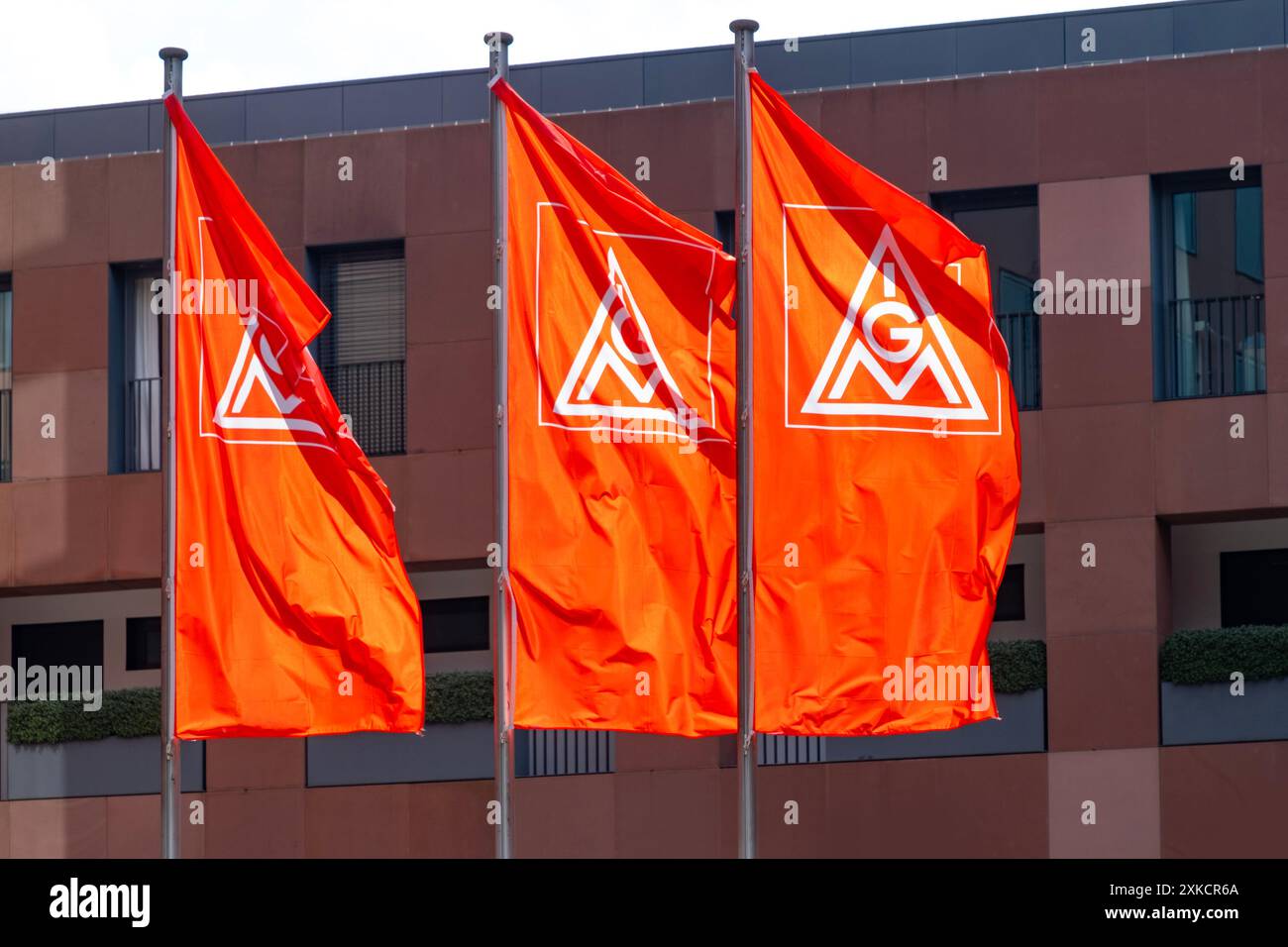 Red IGM flags waving in wind with IG Metall logo prominently, German ...