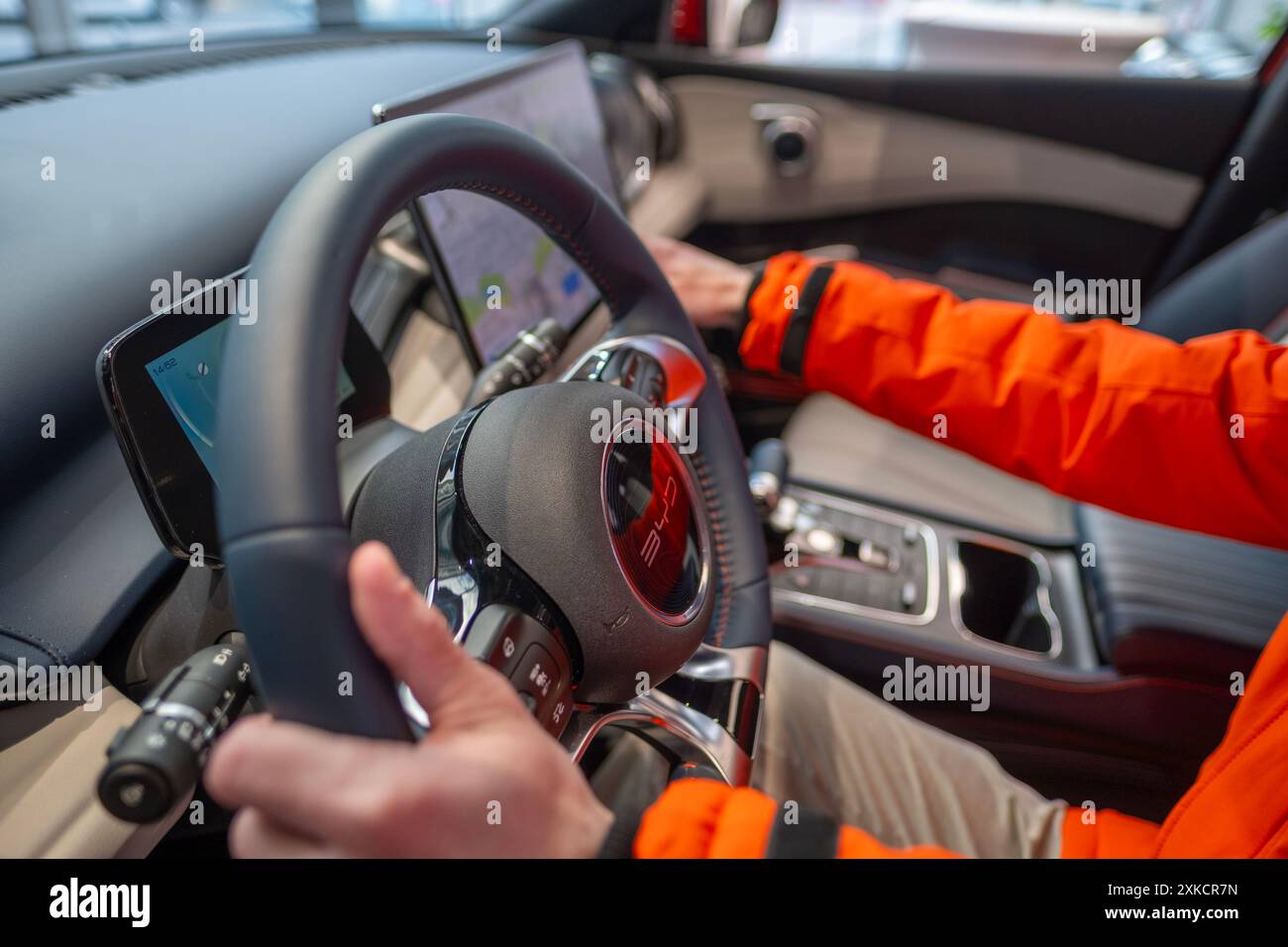 close-up male driver's hand manipulates on electronic display, steering ...