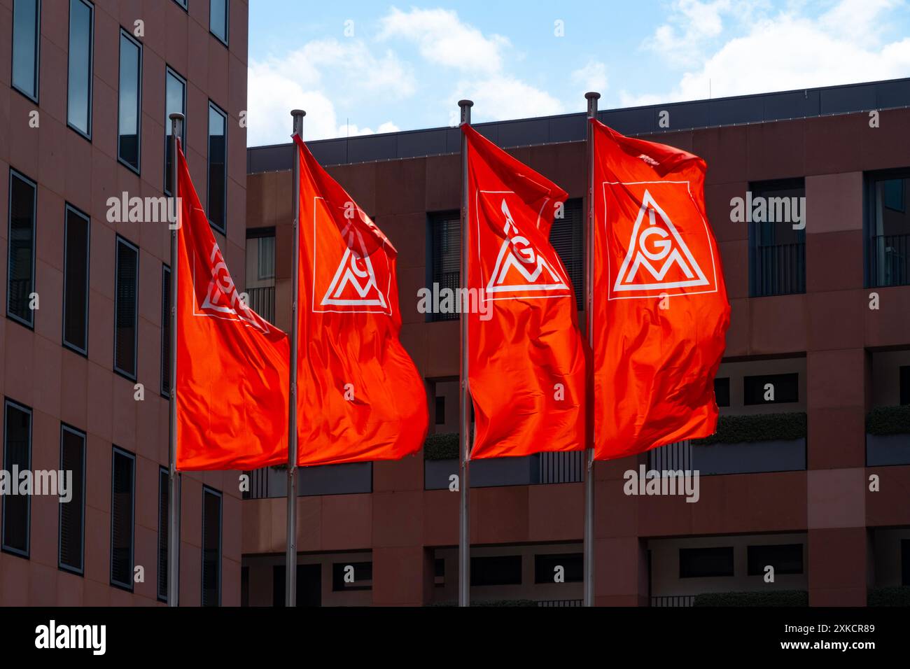 Red IGM flags waving in wind with IG Metall logo prominently, German ...