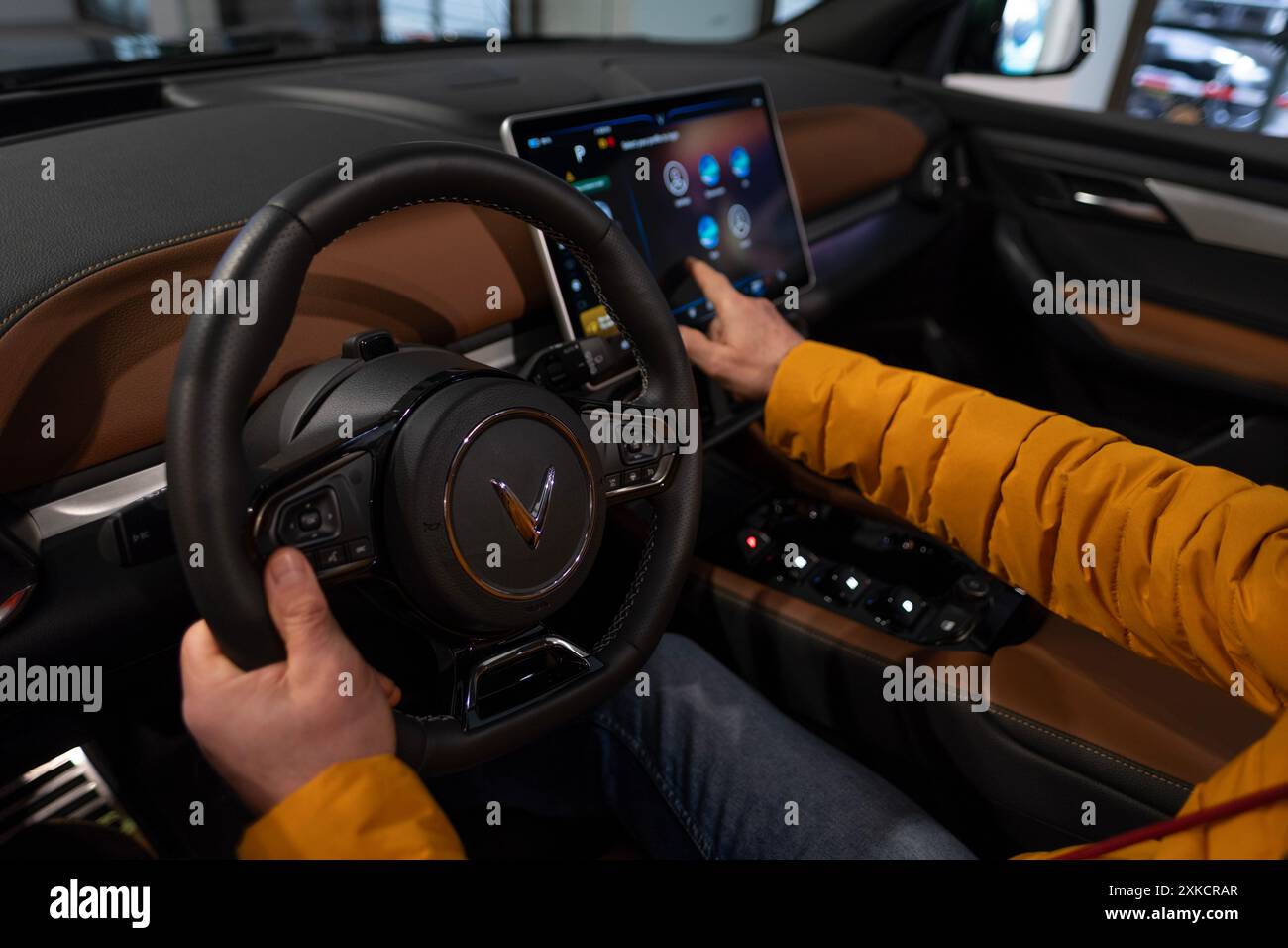 male hands on steering wheel, Interior, cockpit of Vinfast vf 8 ...