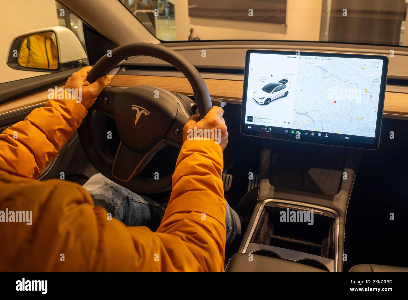 close-up male hands on steering wheel, Tesla electric car model Y ...