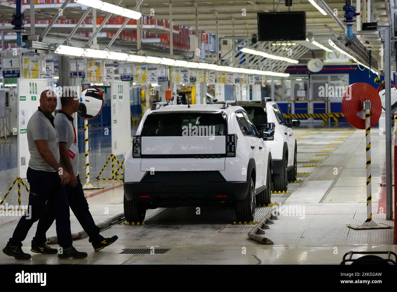 Serbian factory workers pass by all-new Fiat Grande Panda cars in the ...