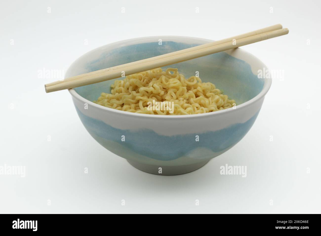 Instant noodles in bowl with chopsticks on white background Stock Photo ...