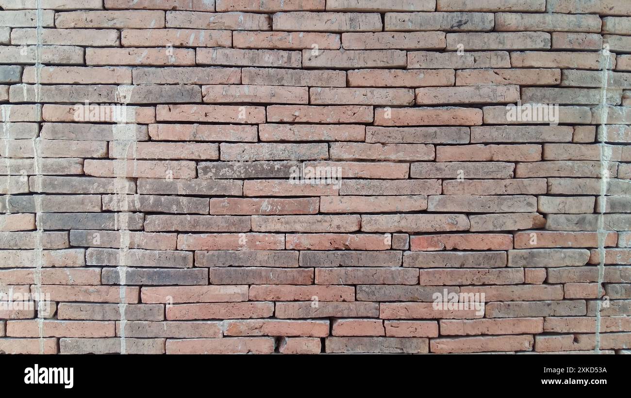 Brick wall background is a wall made of clay bricks, giving the ...