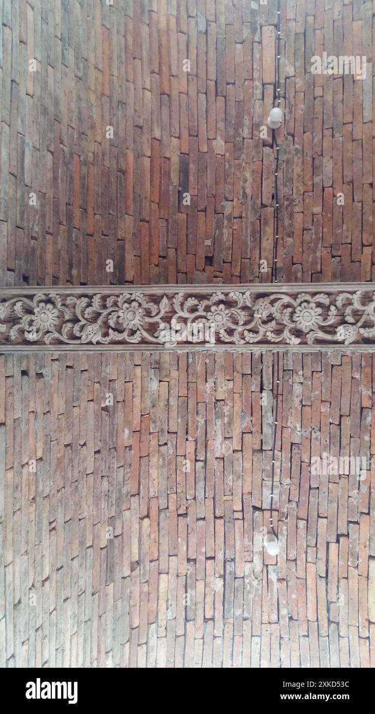 Brick wall background is a wall made of clay bricks, giving the ...