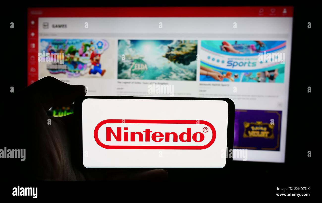 Person holding cellphone with logo of Japanese video game company ...