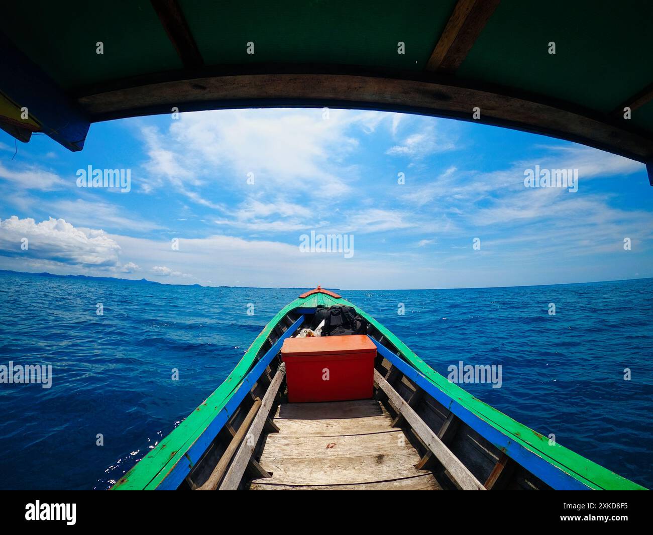 Experience the serene beauty of Sumatra from a traditional boat gliding ...