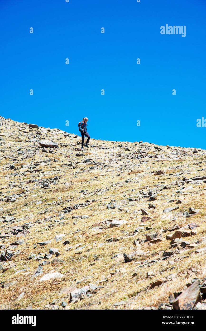 Single woman hiking down from the summit of Mt Walter in the Sangre de ...