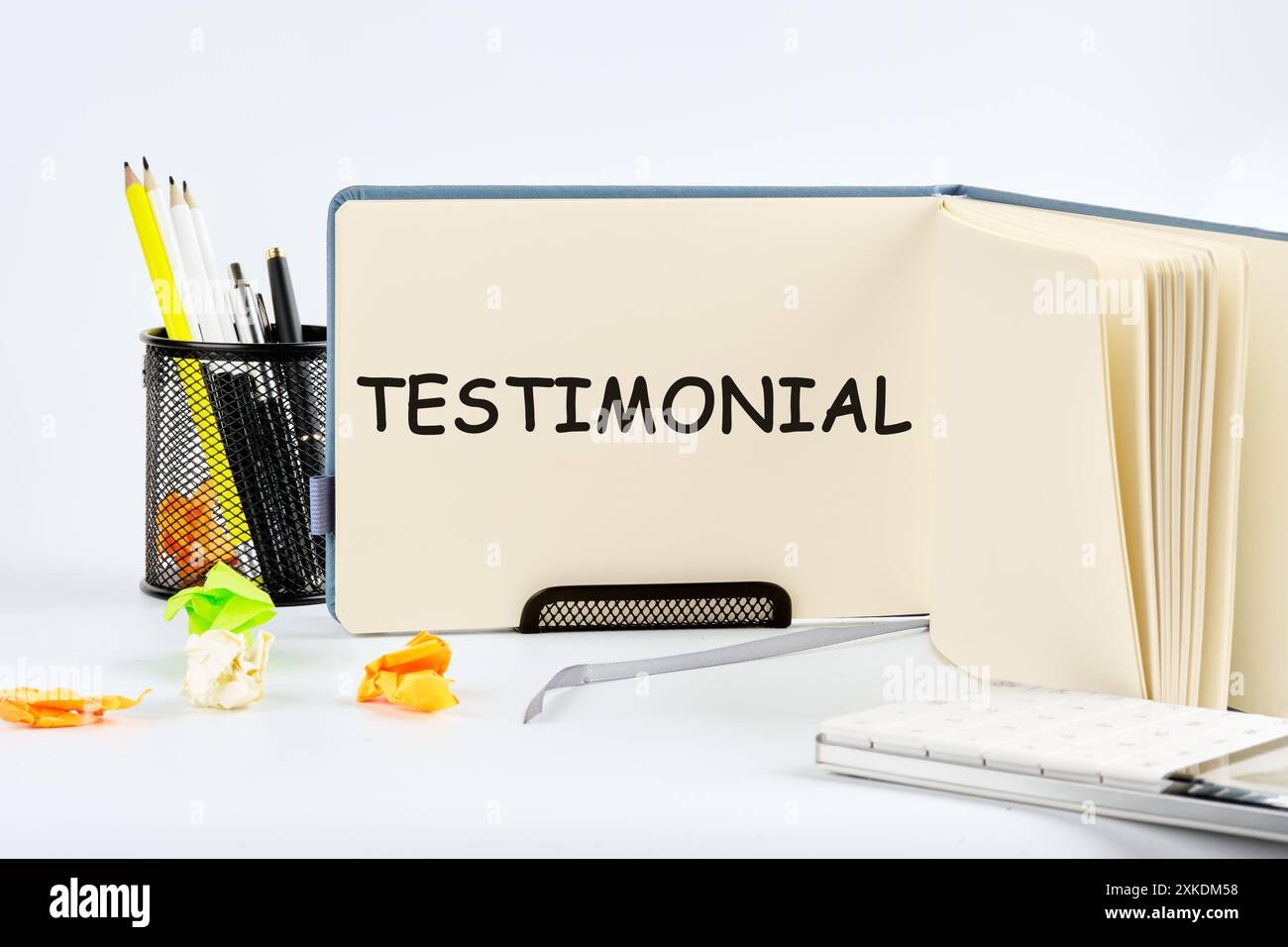 Business concept. TESTIMONIAL is written in a notebook on a table on a ...
