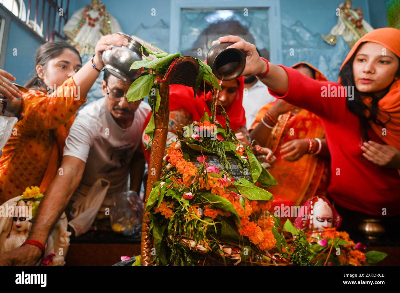 NOIDA, INDIA - JULY 22: Devotees perform rituals on the first Monday of ...