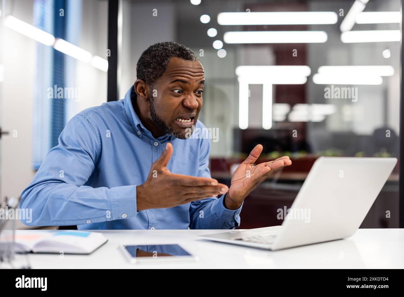 Frustrated businessman sitting in office expressing stress and ...