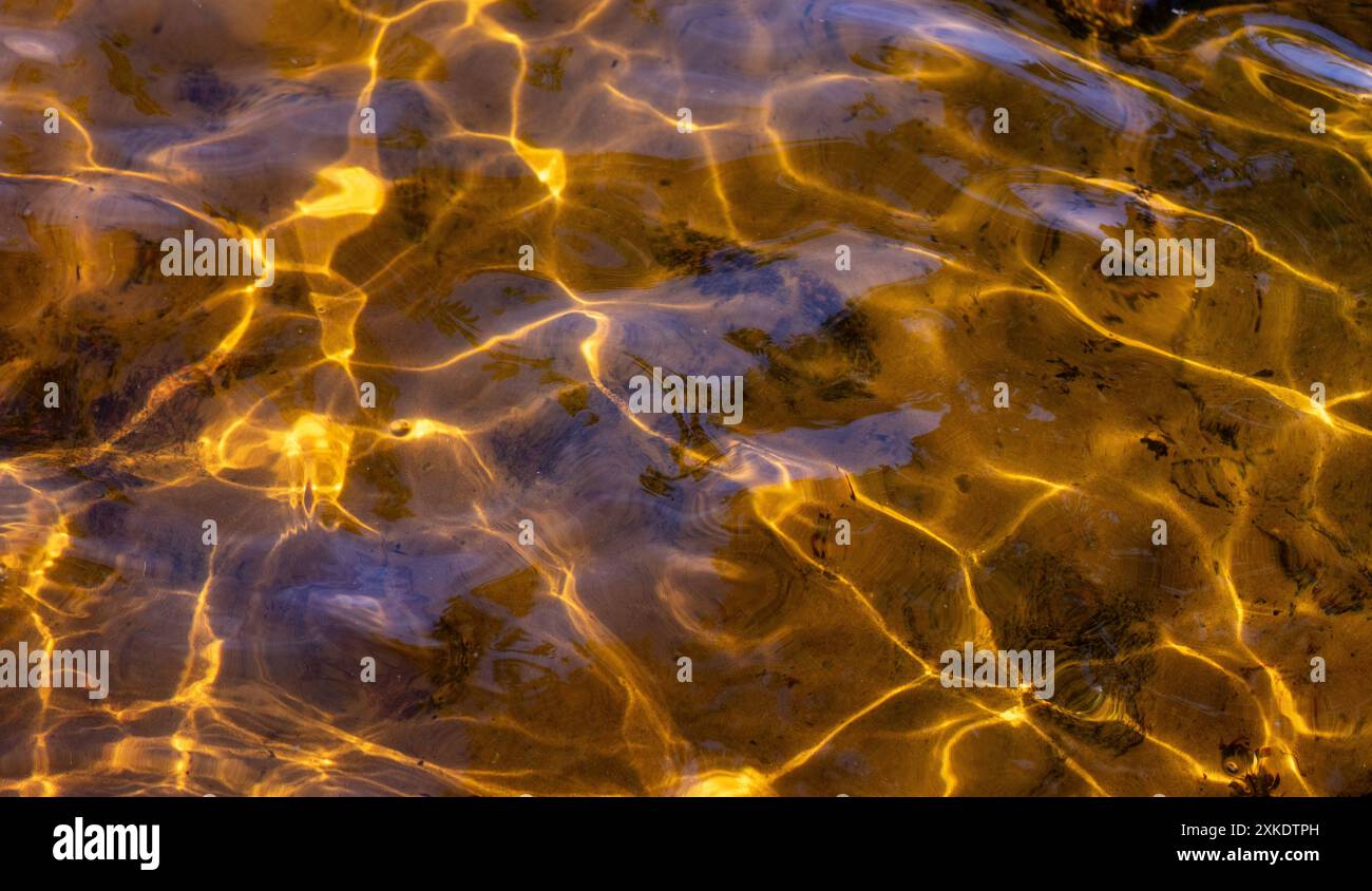 Golden wavy water reflections. Dynamic background texture Stock Photo ...