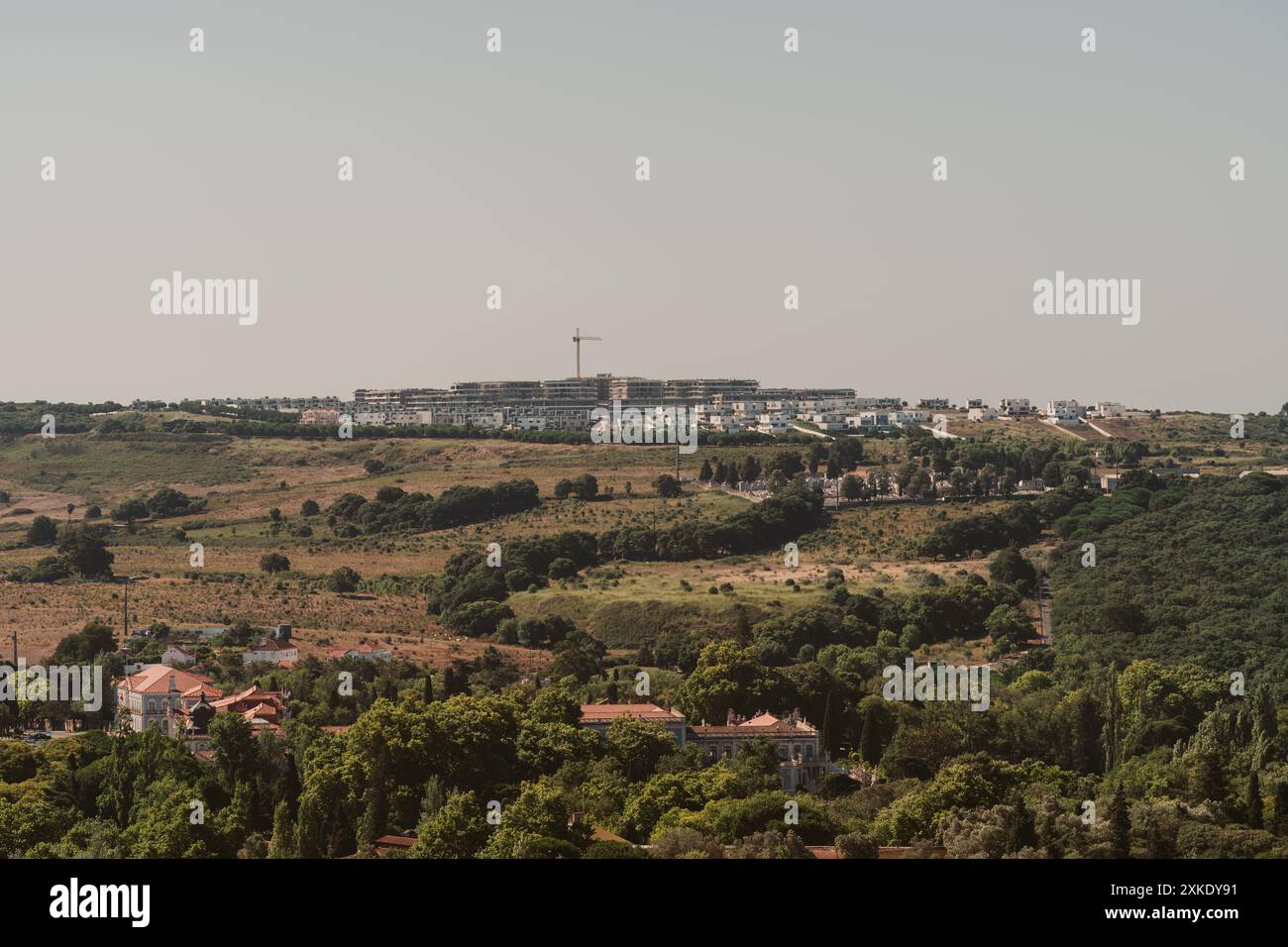 A panoramic view of a hilly landscape with scattered houses and ...