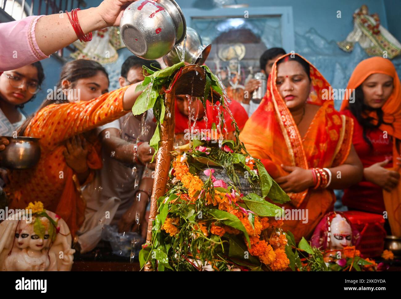 NOIDA, INDIA - JULY 22: Devotees perform rituals on the first Monday of ...