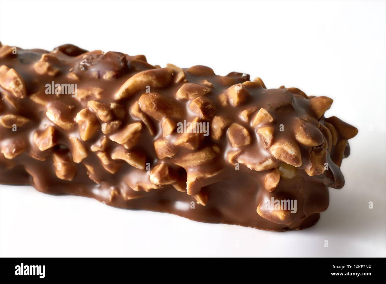 Fragment of chocolate wafer bar with caramel and peanuts isolated on ...