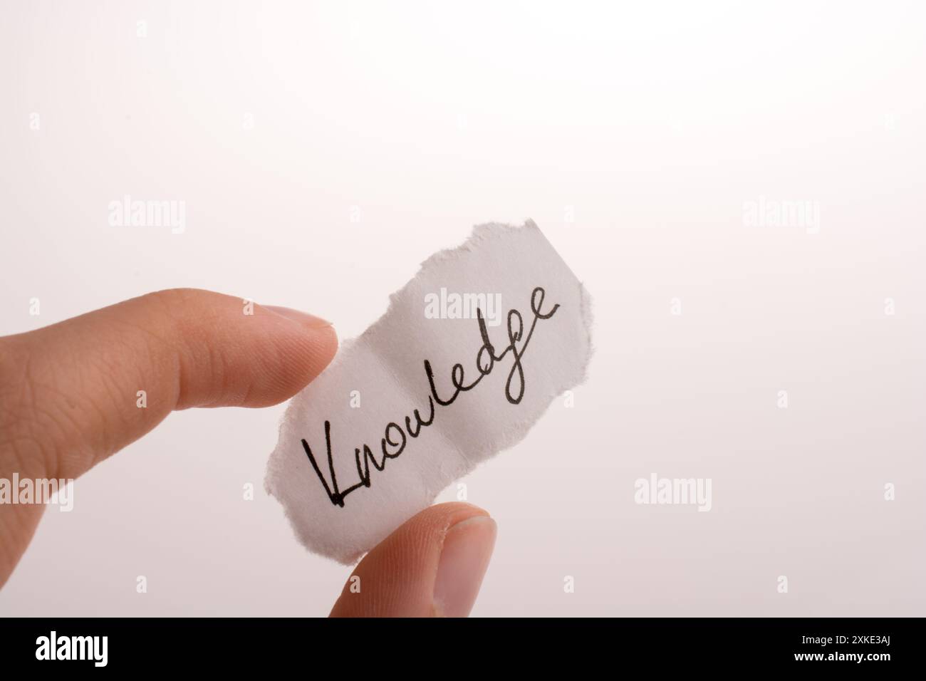 Knowledge written torn paper on a white background Stock Photo - Alamy