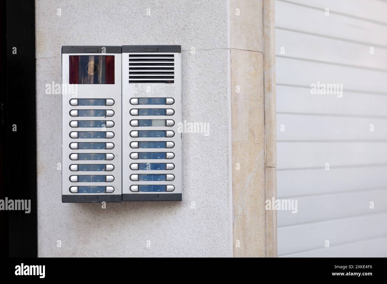 Modern entrance door intercom. Doorbells with empty name tag cards. Outdoor intercom outside ...