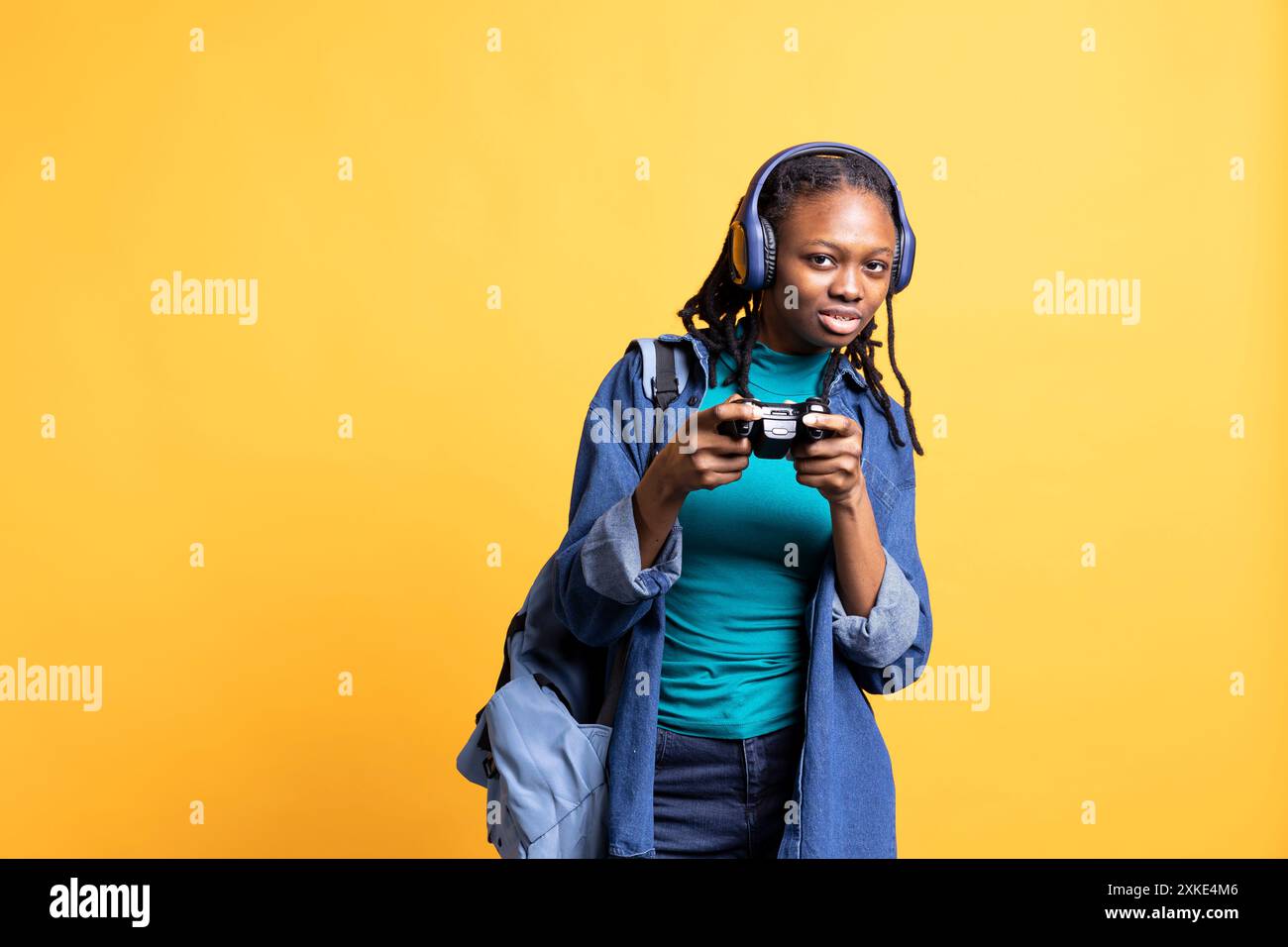 Portrait of cheerful woman playing videogames, holding controller ...