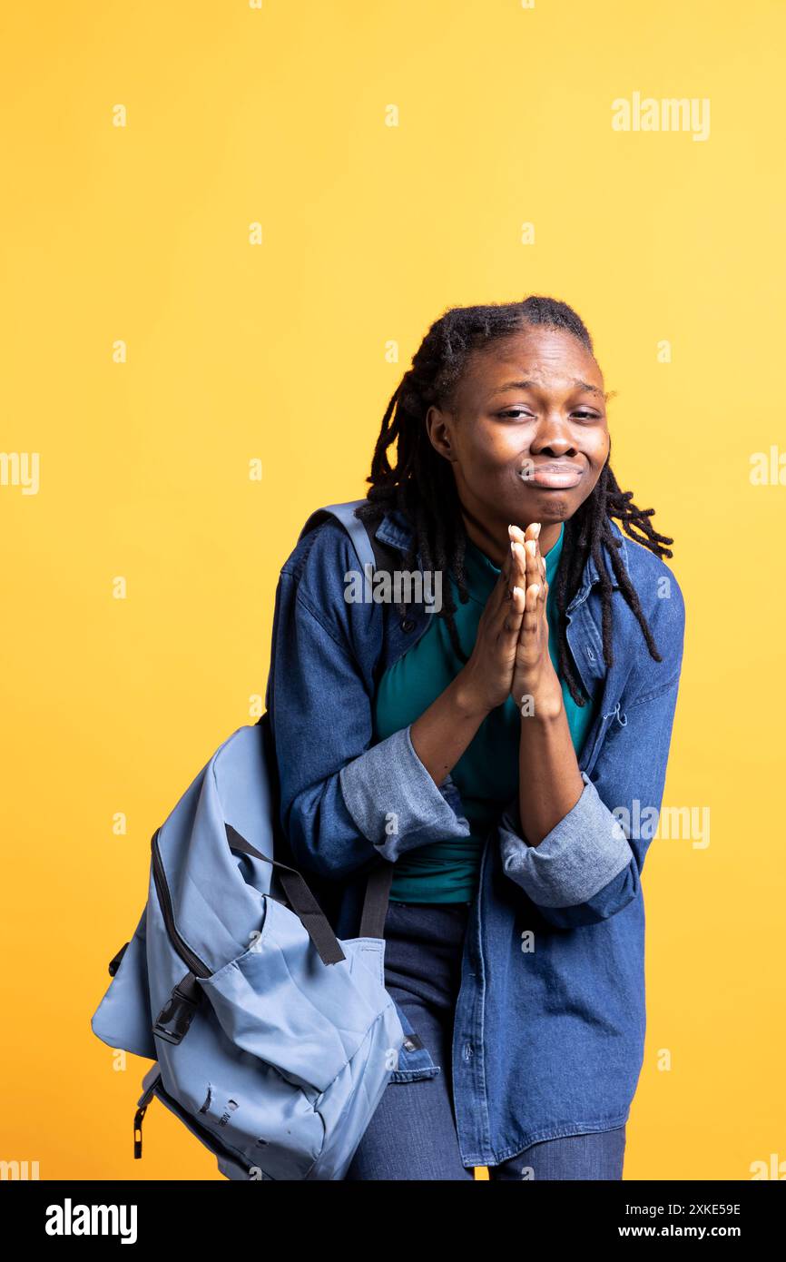Friendly african american woman putting hands together in apology ...