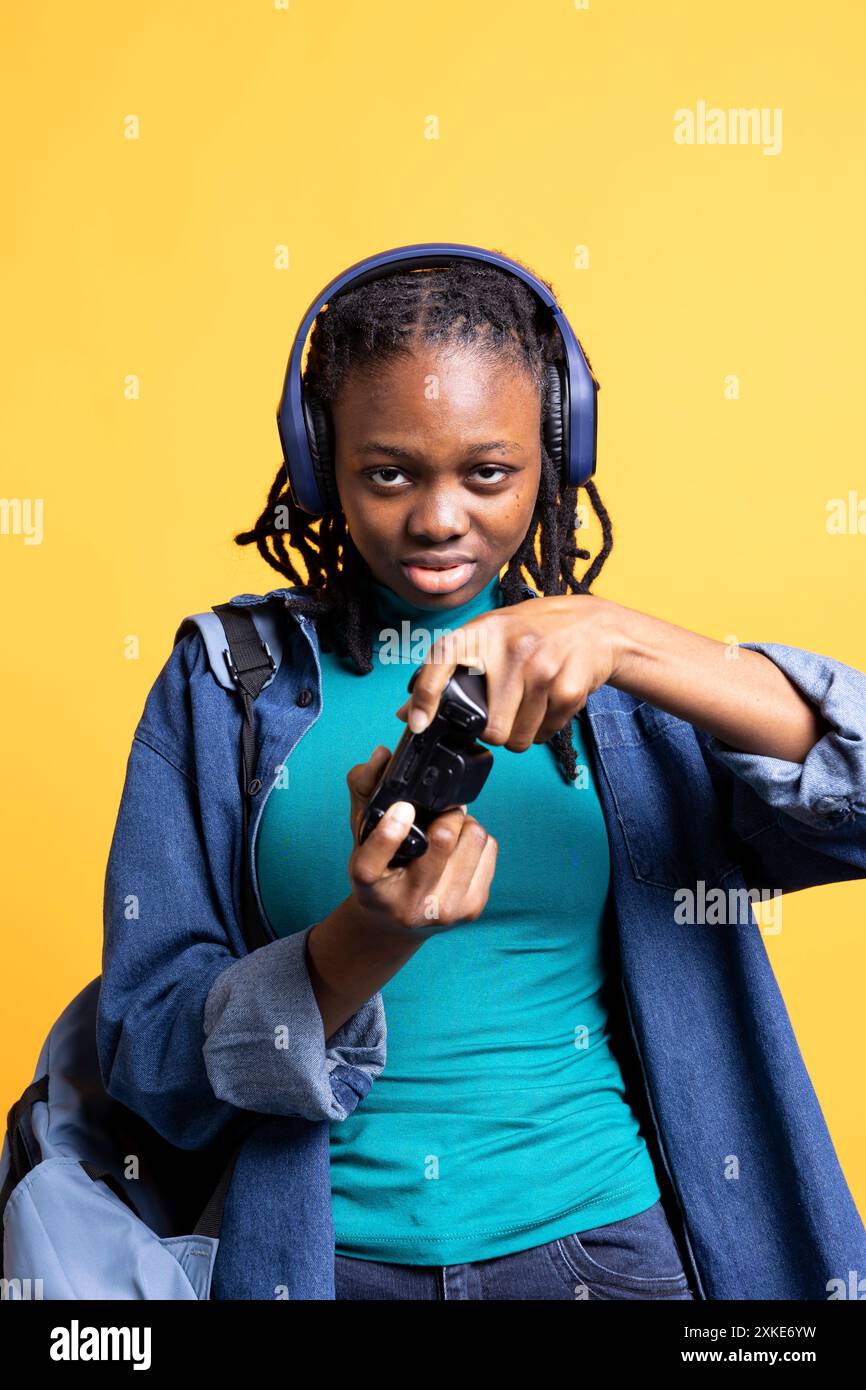 Portrait of woman playing videogames with controller, hearing sounds ...