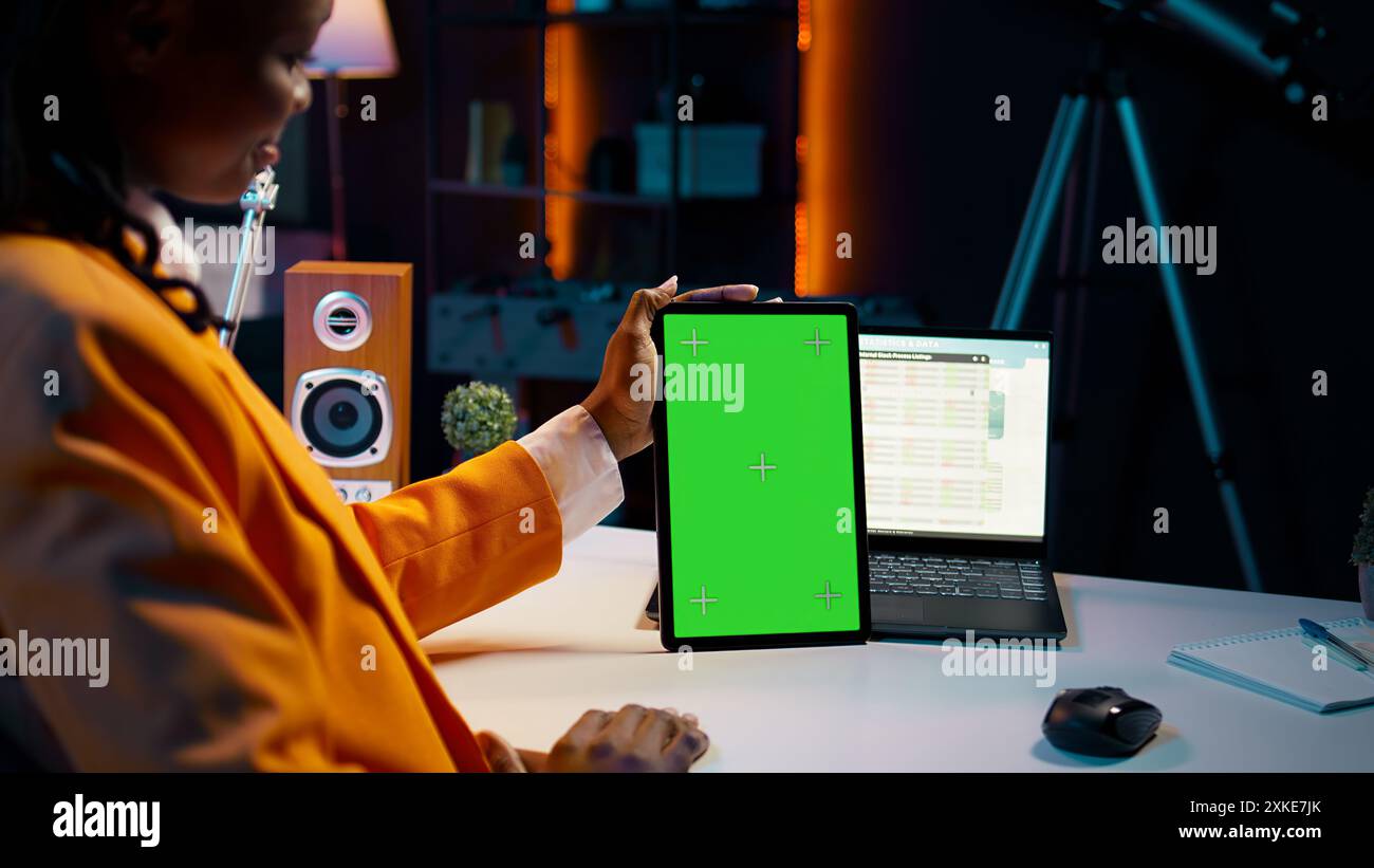 African american girl holding tablet with greenscreen layout ...