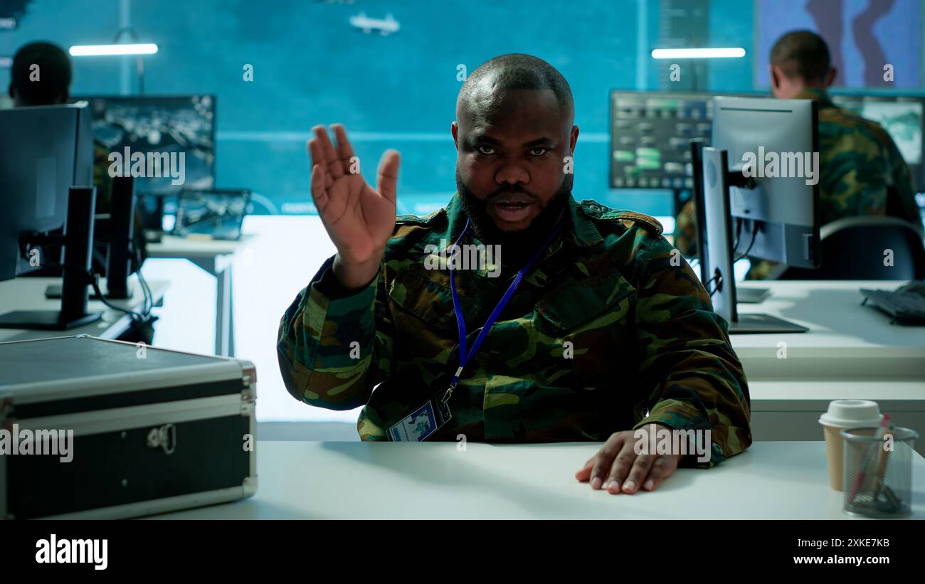 Military officer participates in a secure videoconference call in ...