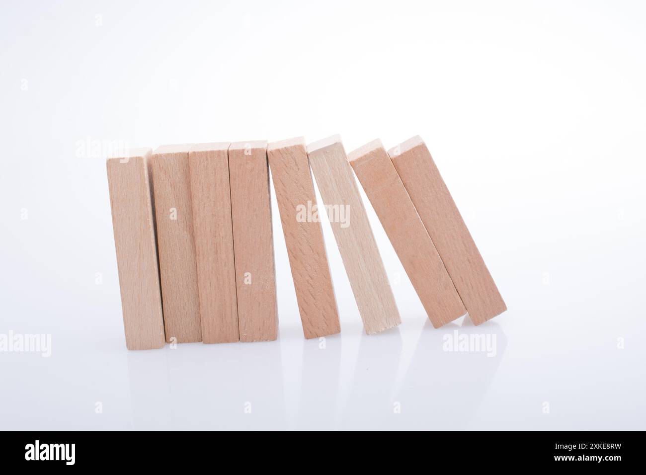 Wooden Domino Blocks in a line on a white background Stock Photo - Alamy
