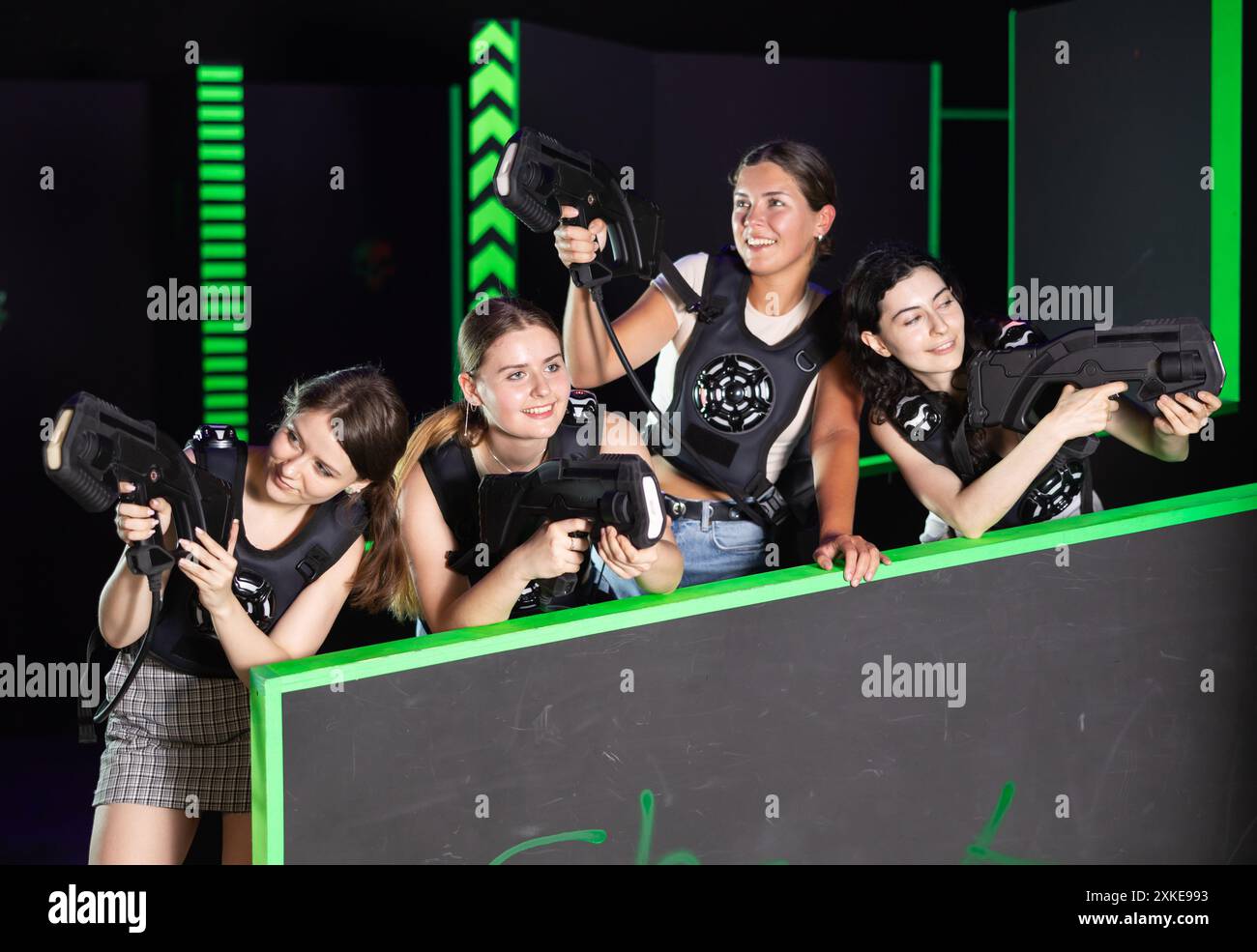 Girls play laser tag, jokingly fight with light weapons Stock Photo - Alamy