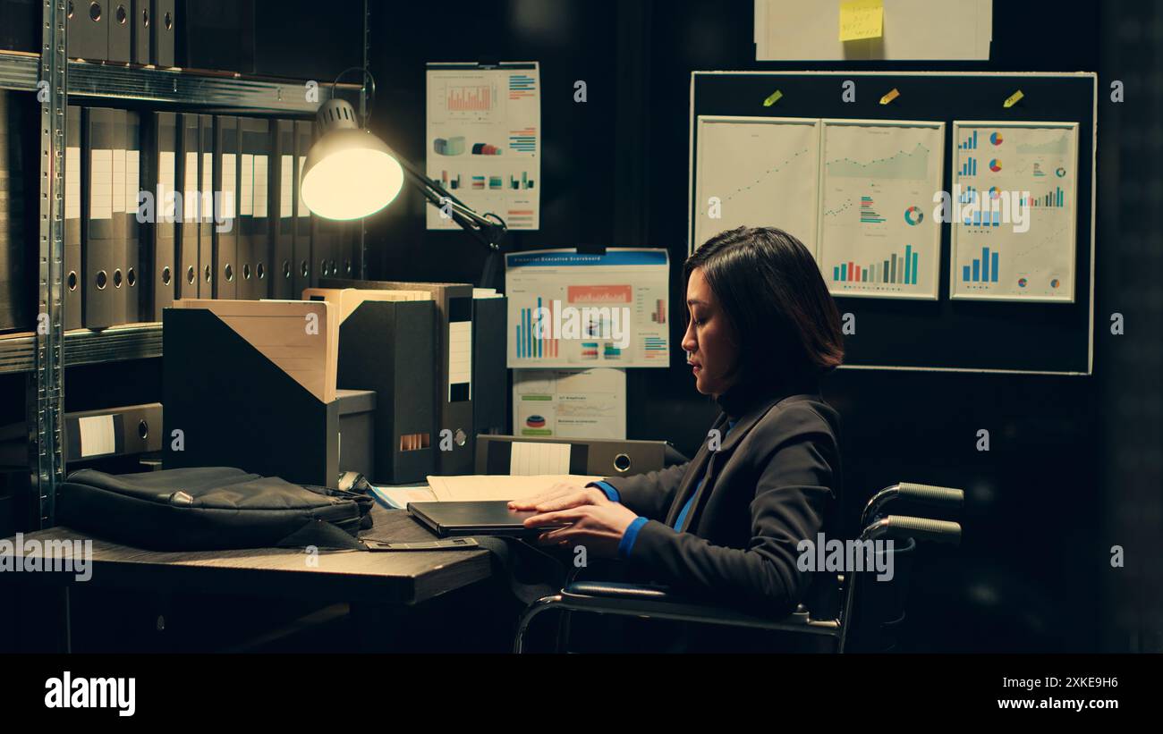 Detective with impairment studying classified folders in archive room ...