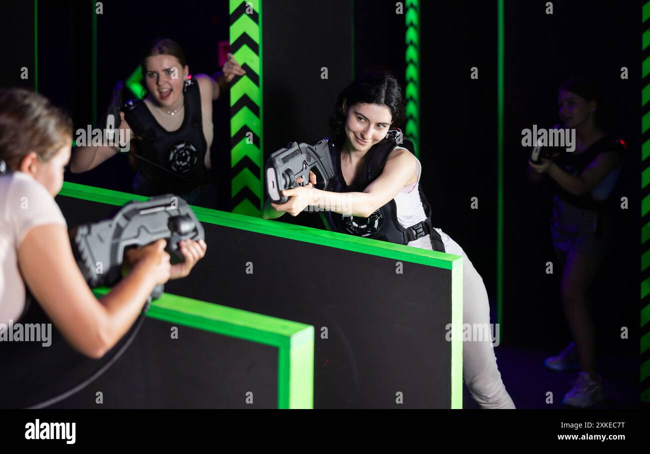 Girls play laser tag, jokingly fight with light weapons Stock Photo - Alamy