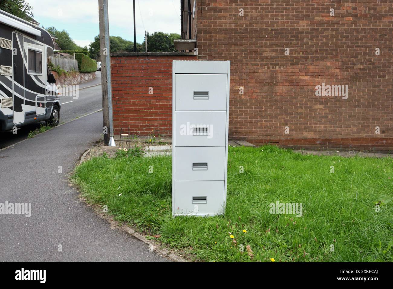 A filing cabinet on a roadside grass verge on a housing estate ...