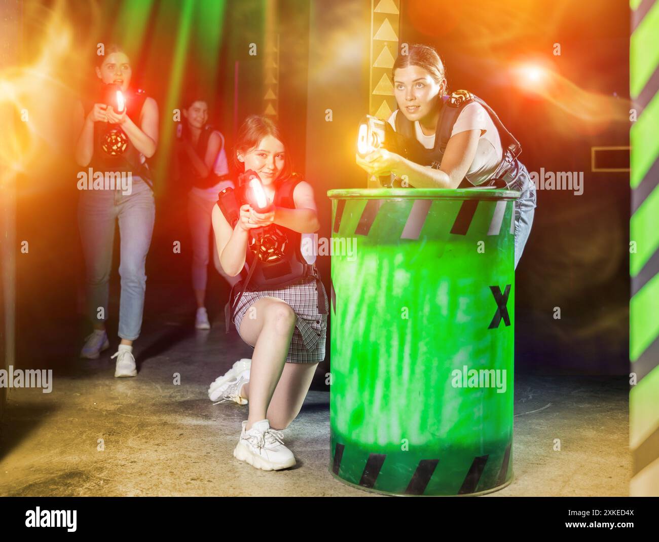 Girls play laser tag, jokingly fight with light weapons Stock Photo - Alamy