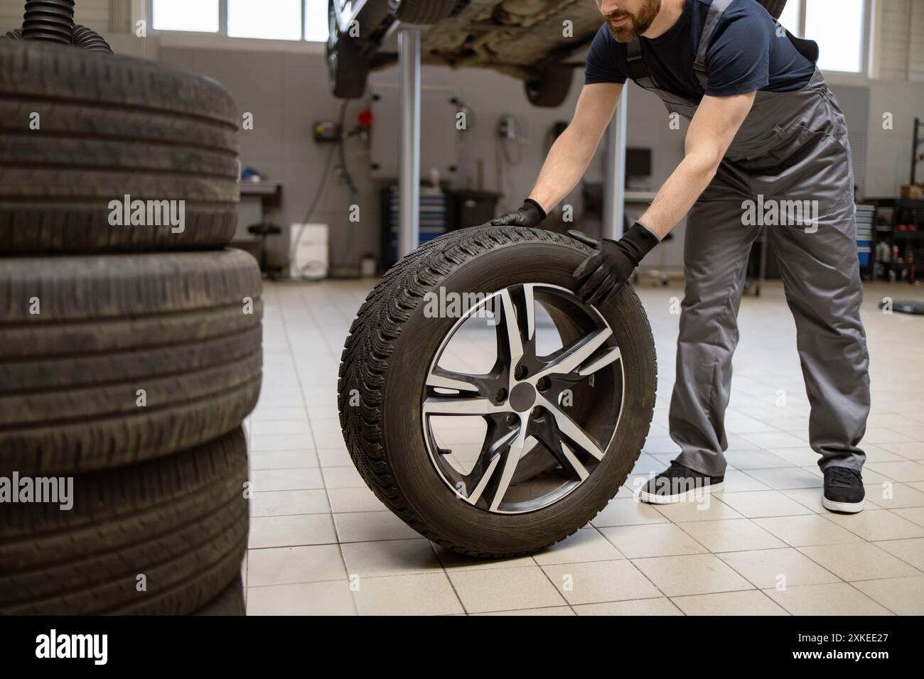 Young mechanic in uniform changing hi-res stock photography and images ...