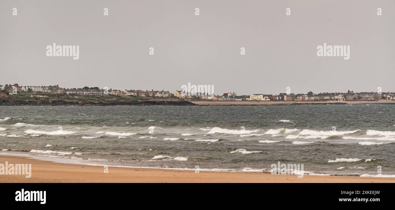 The waves and surf of the North Sea with the village of Whitley Bay in ...