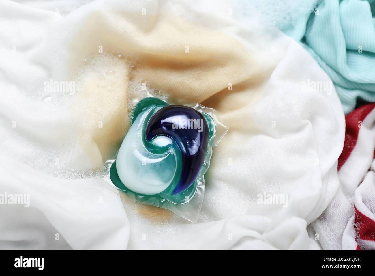 Laundry detergent on wet clothes, closeup Stock Photo - Alamy