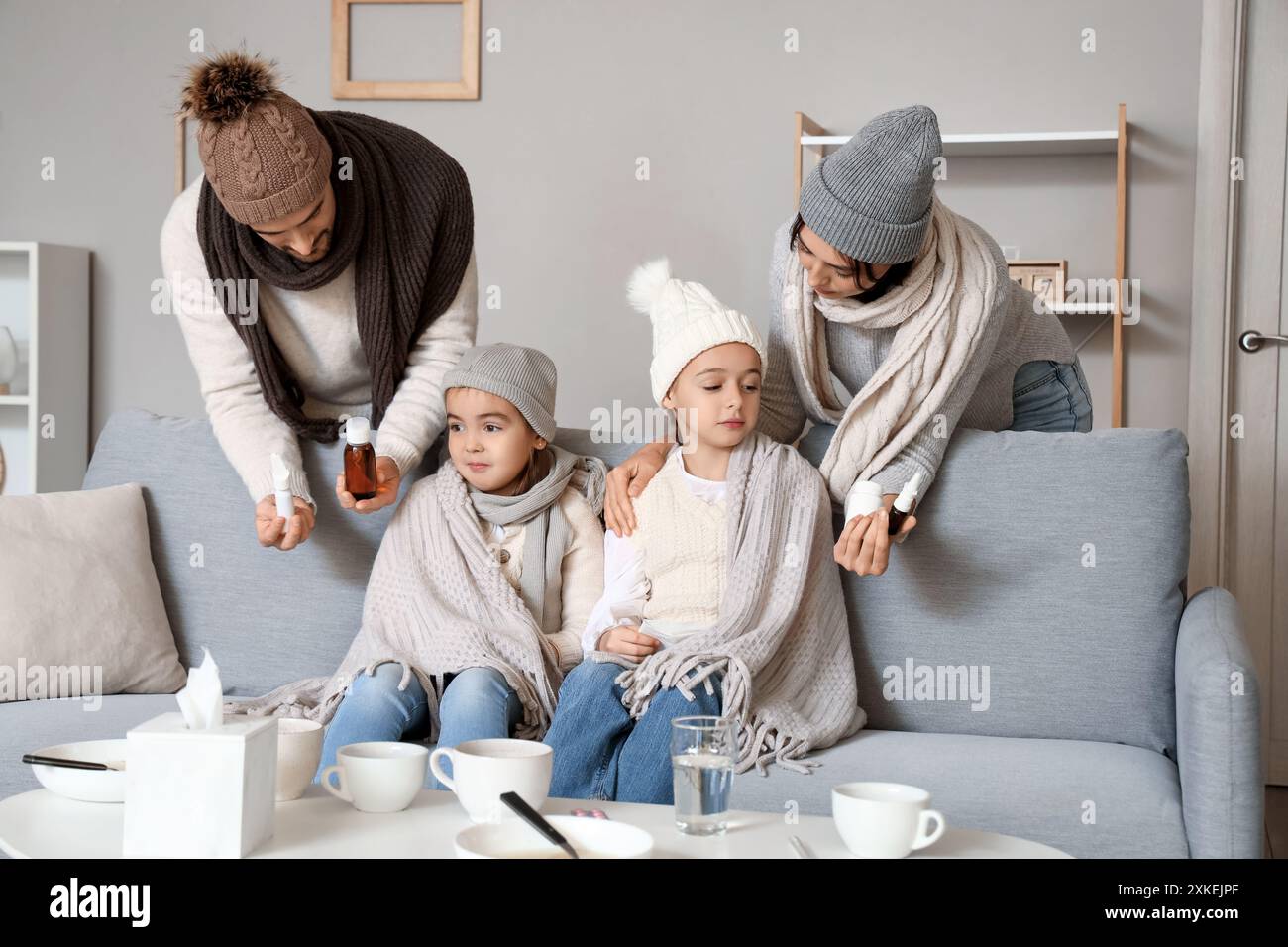 Parents giving medications to their ill little daughters at home Stock ...