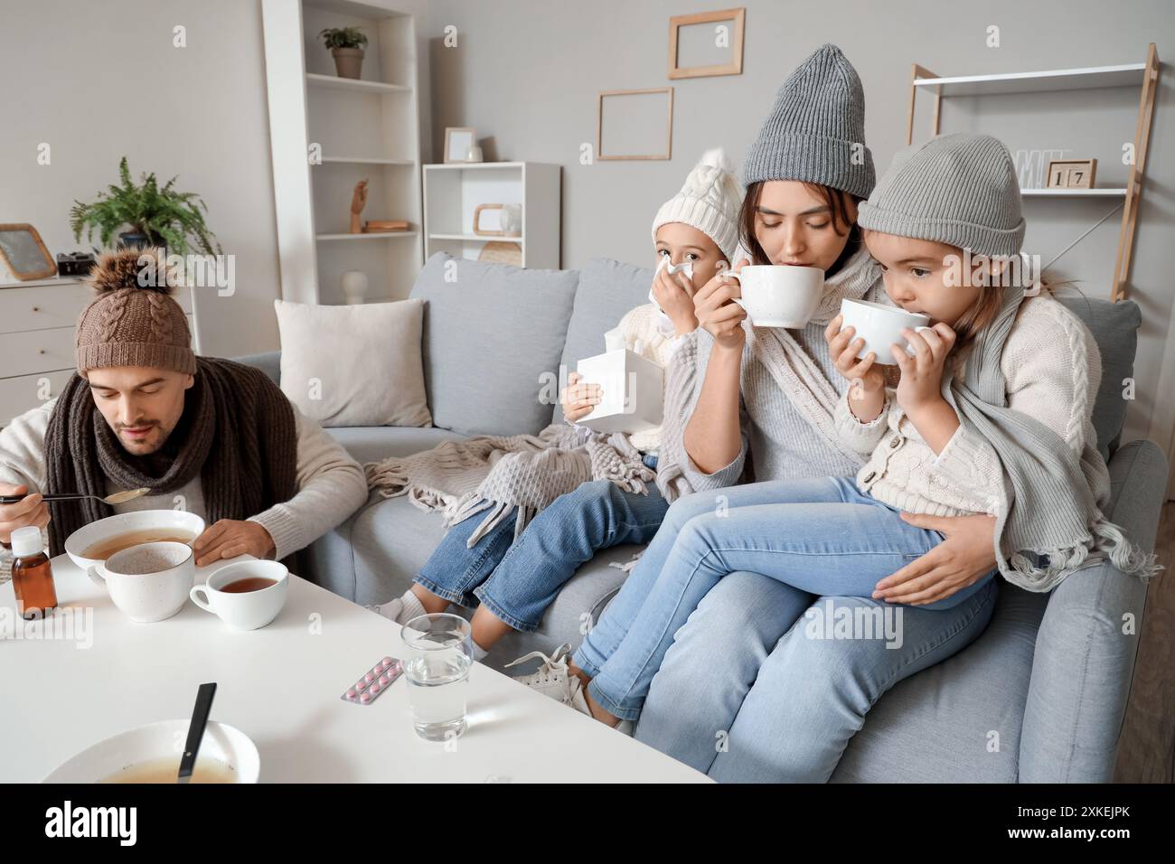 Ill little girls with their parents drinking tea at home Stock Photo ...
