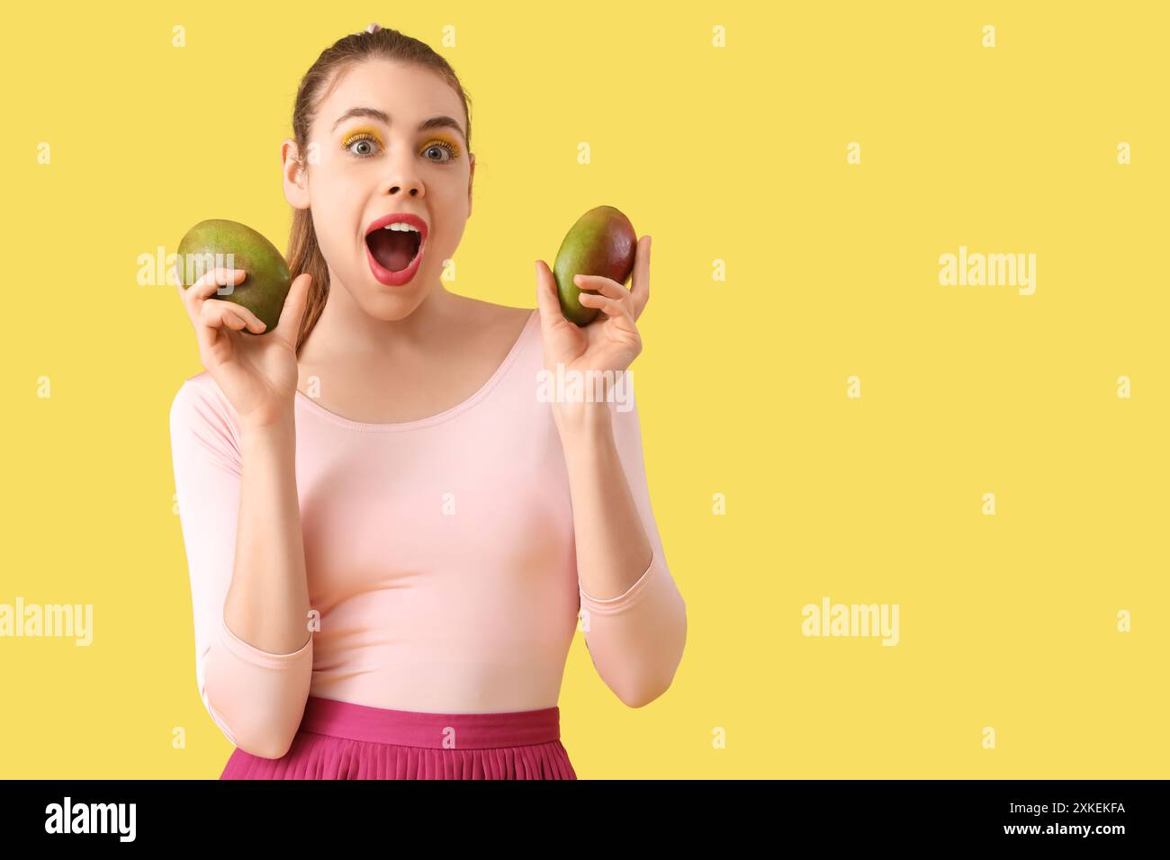 Shocked young woman with sweet mango fruits on yellow background Stock ...