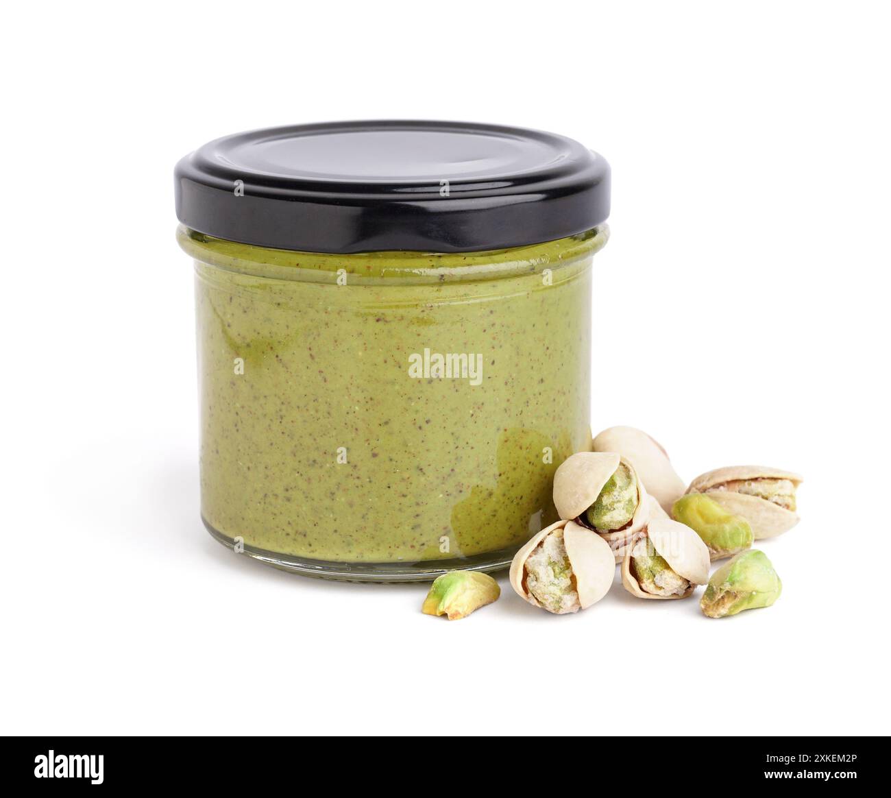 Tasty pistachio paste in jar on white background Stock Photo - Alamy