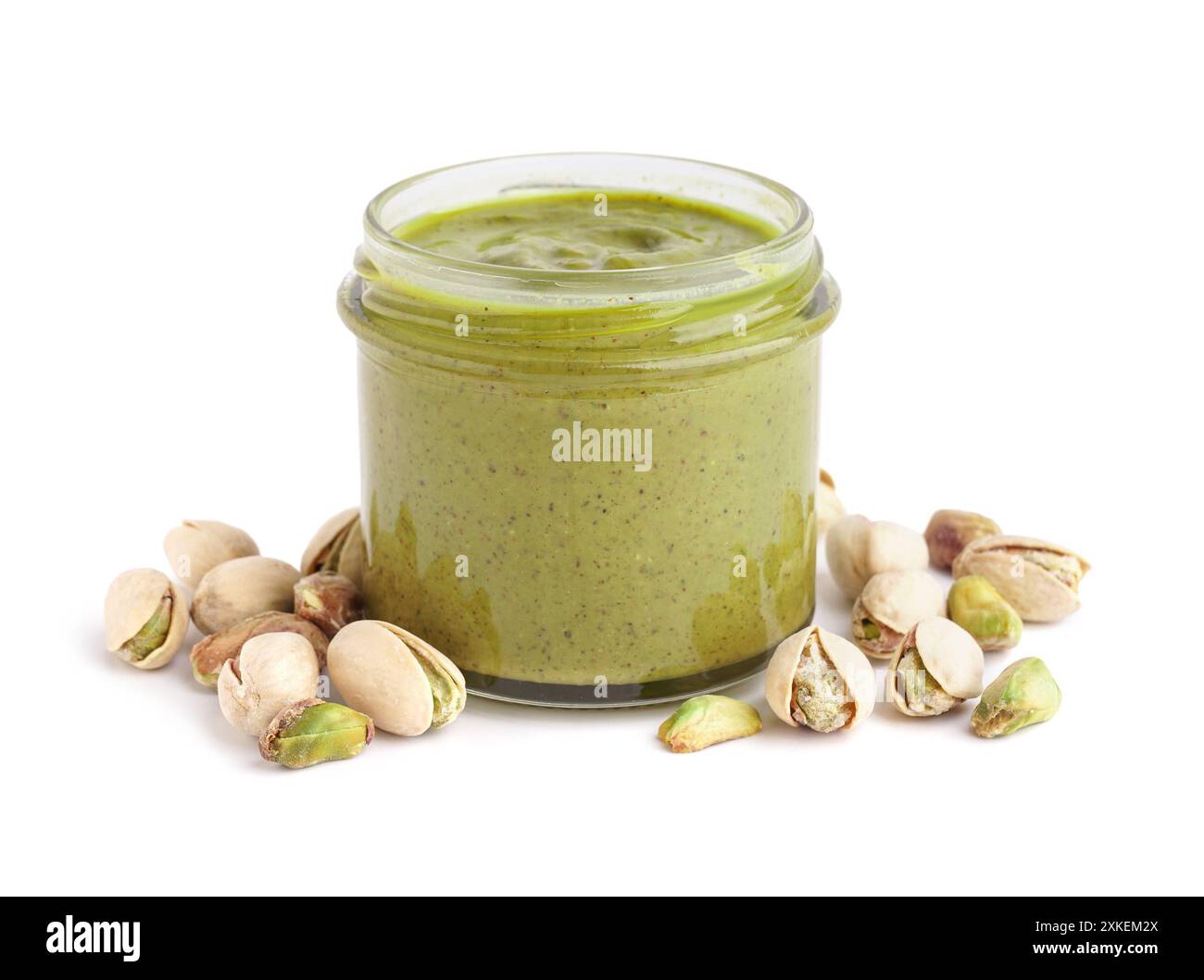 Tasty pistachio paste in jar on white background Stock Photo - Alamy