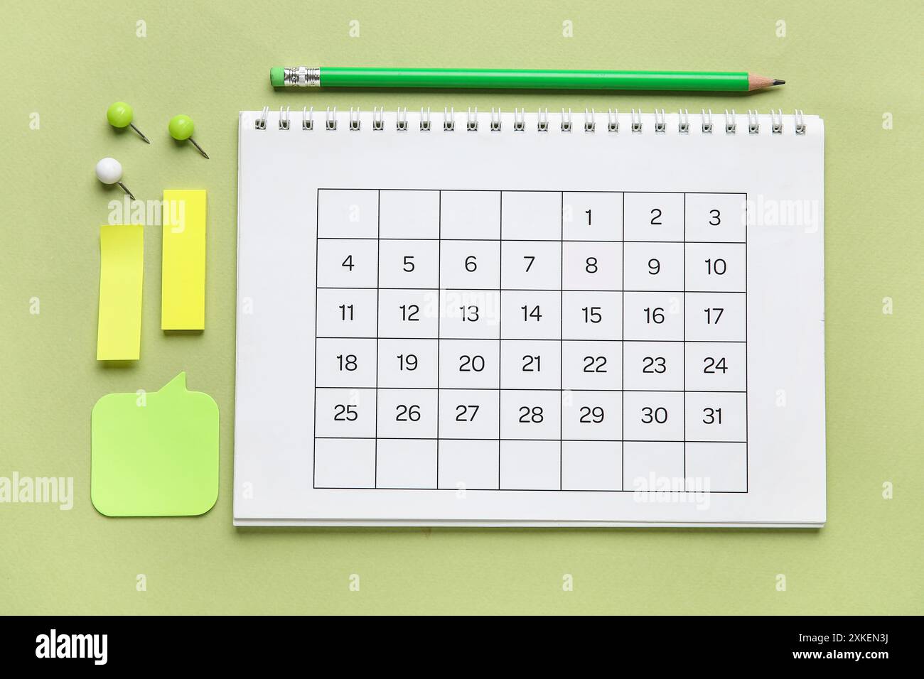Calendar with office stationery on green background Stock Photo - Alamy