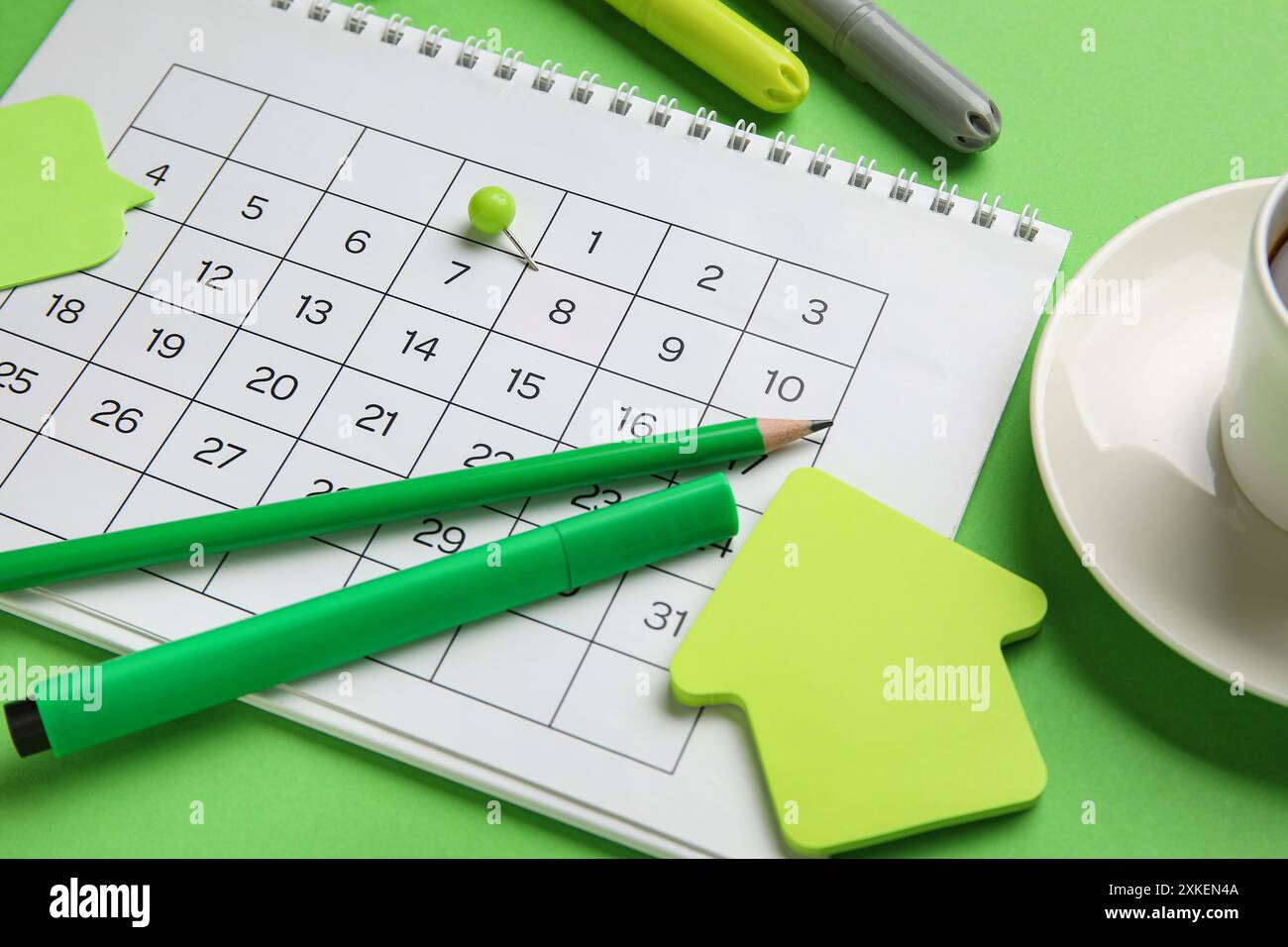 Calendar with office stationery on green background Stock Photo - Alamy